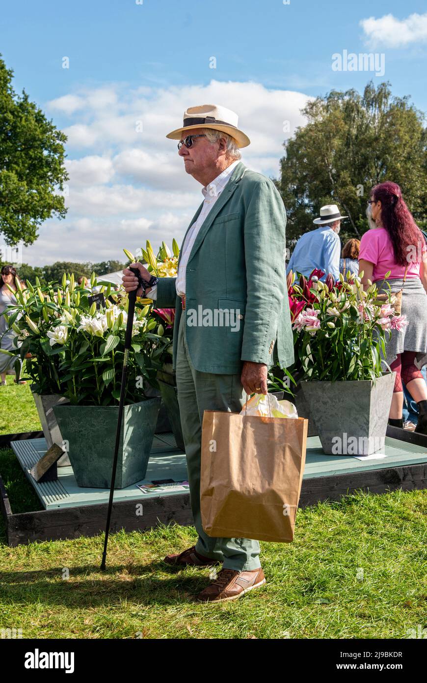 A gentleman wearing country style cloths including Panama hat and cane ...