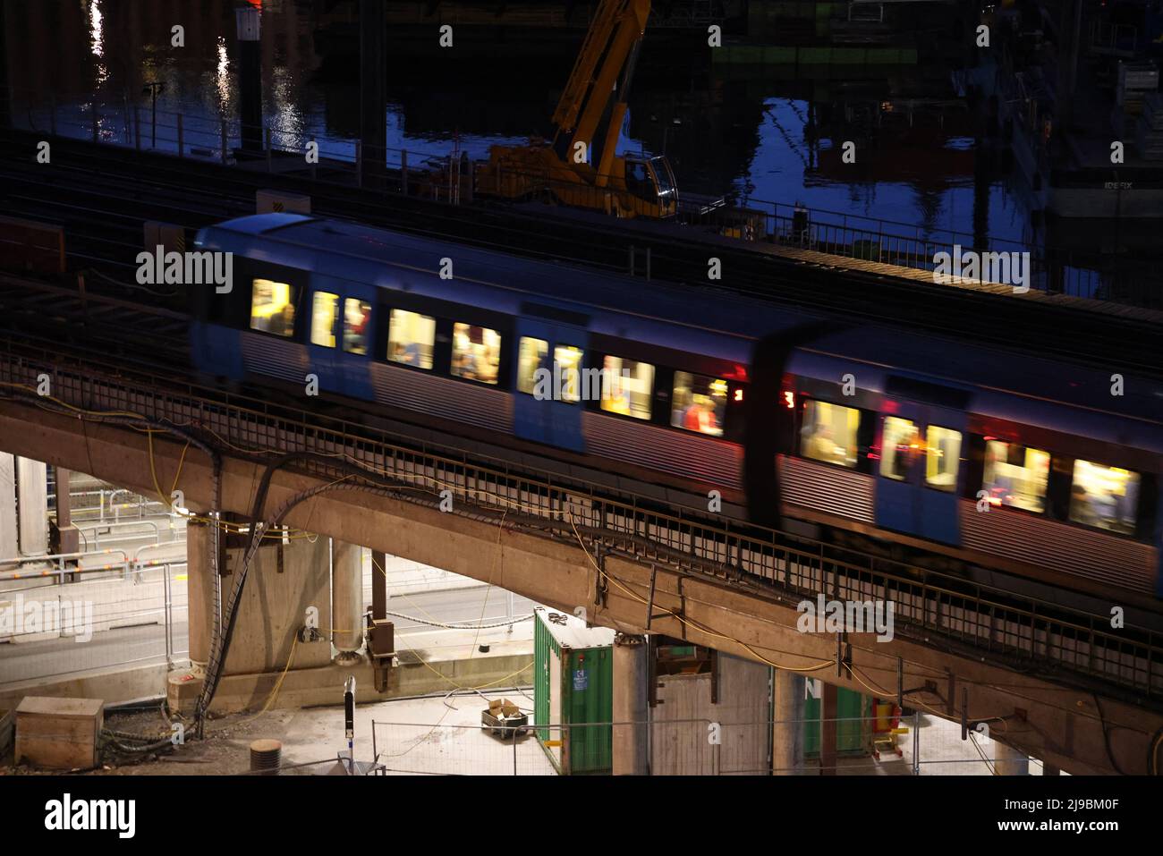 Moving metro train over a bridge in Stockholm in the evening; light ...