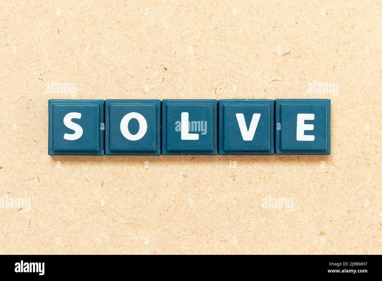 Tile alphabet letter in word solve on wood background Stock Photo - Alamy