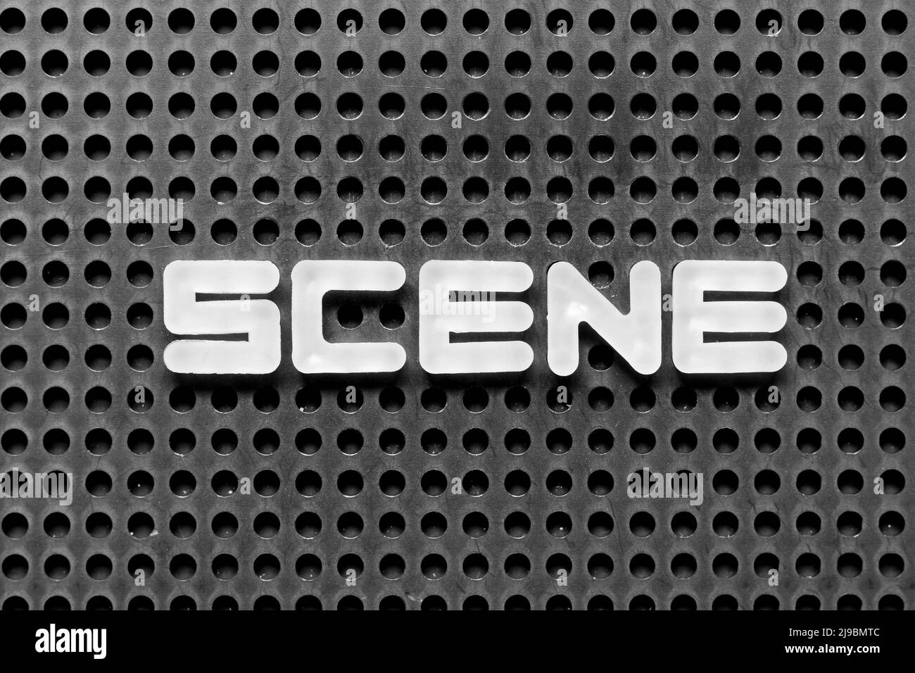 White alphabet letter in word scene on black pegboard background Stock ...