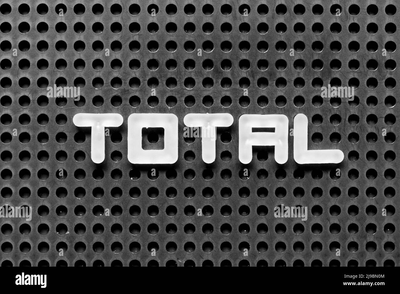 White alphabet letter in word total on black pegboard background Stock ...
