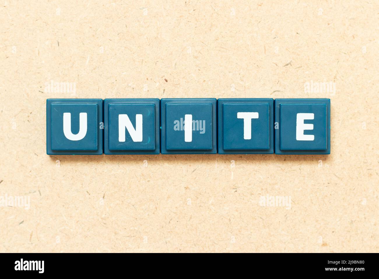 Tile alphabet letter in word unite on wood background Stock Photo - Alamy