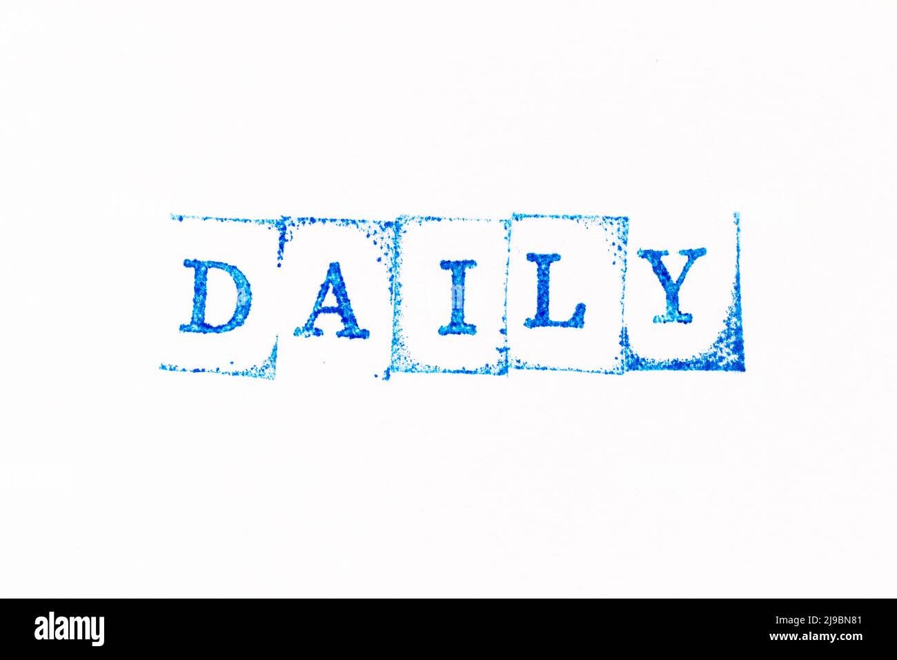 Blue color ink rubber stamp in word daily on white paper background ...
