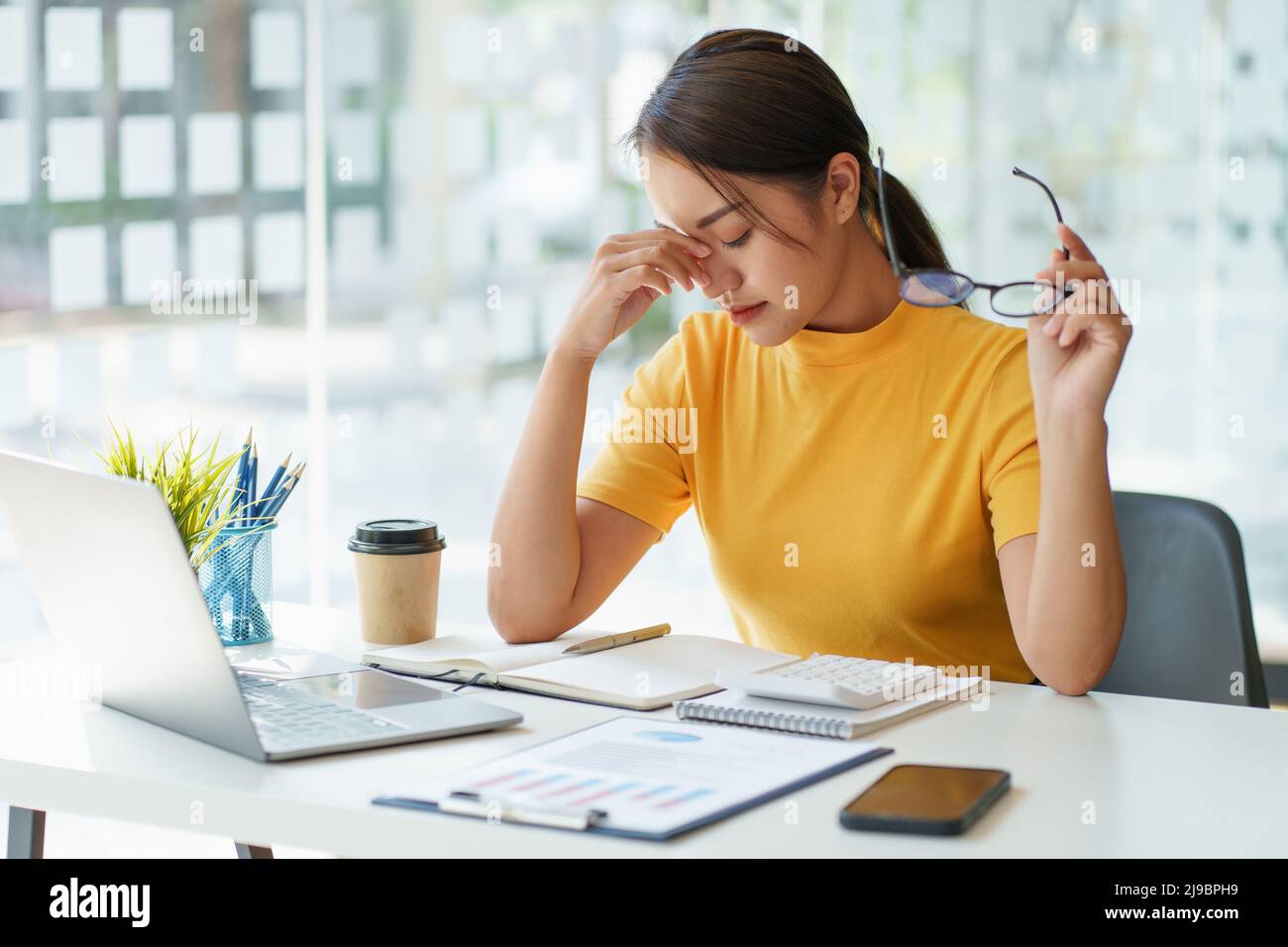 A portrait of Asian business woman worry about marketing plan of this ...