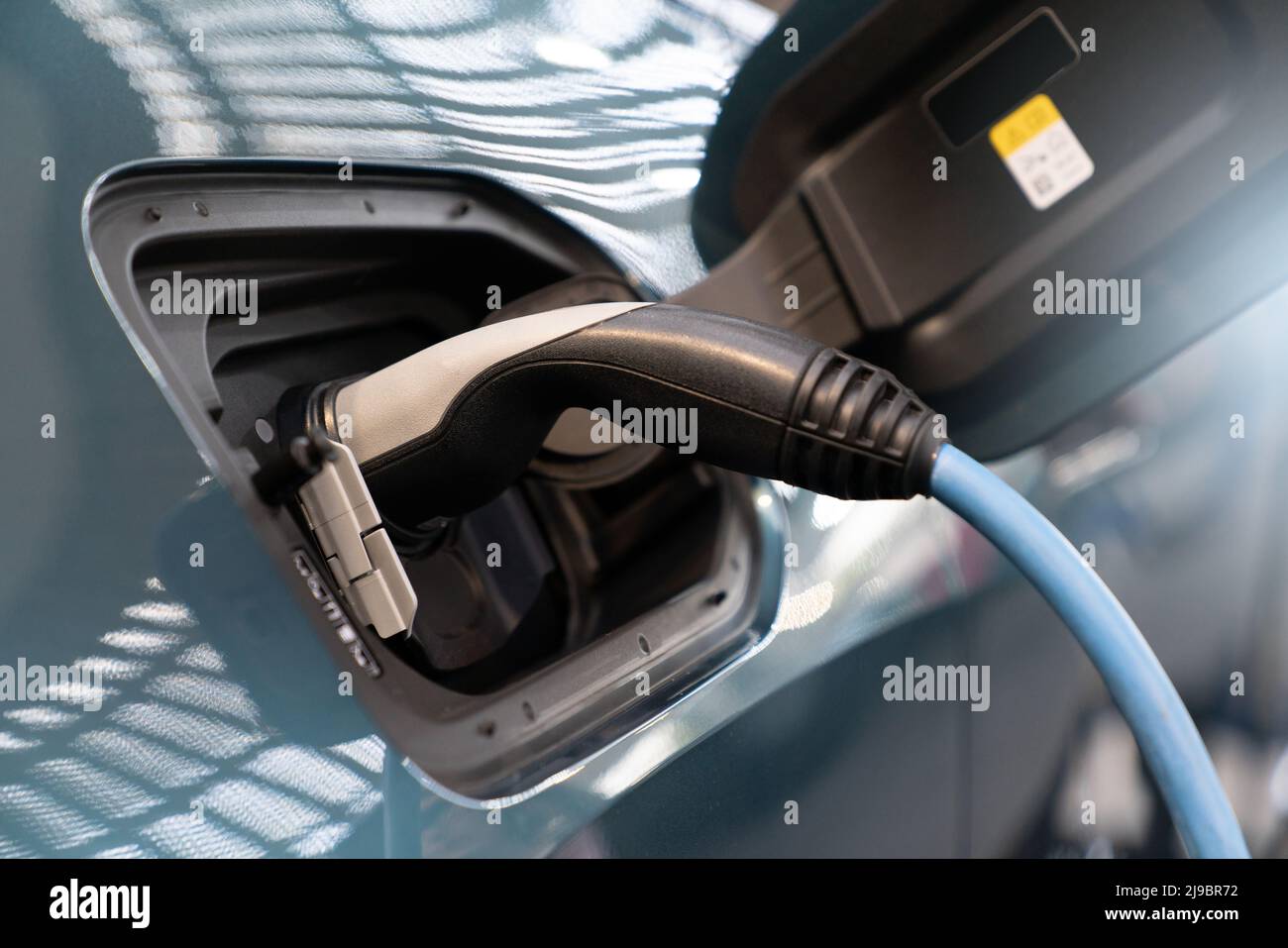 Close up of electric car with a connected charging cable Stock Photo ...