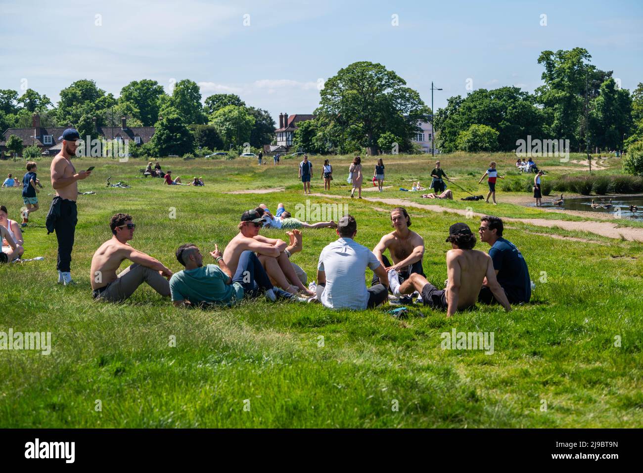 London UK, 22 May 2022. A group of men relaxing on a hot day on ...