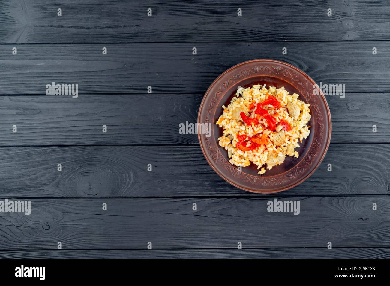 Traditional Asian dish - rice pilaf, vegetables and meat in a plate on ...