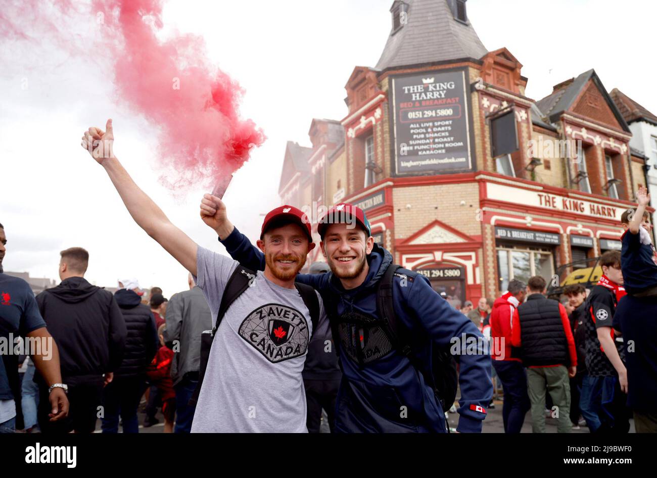 Liverpool fans light flares as they gather outside the ground prior to ...