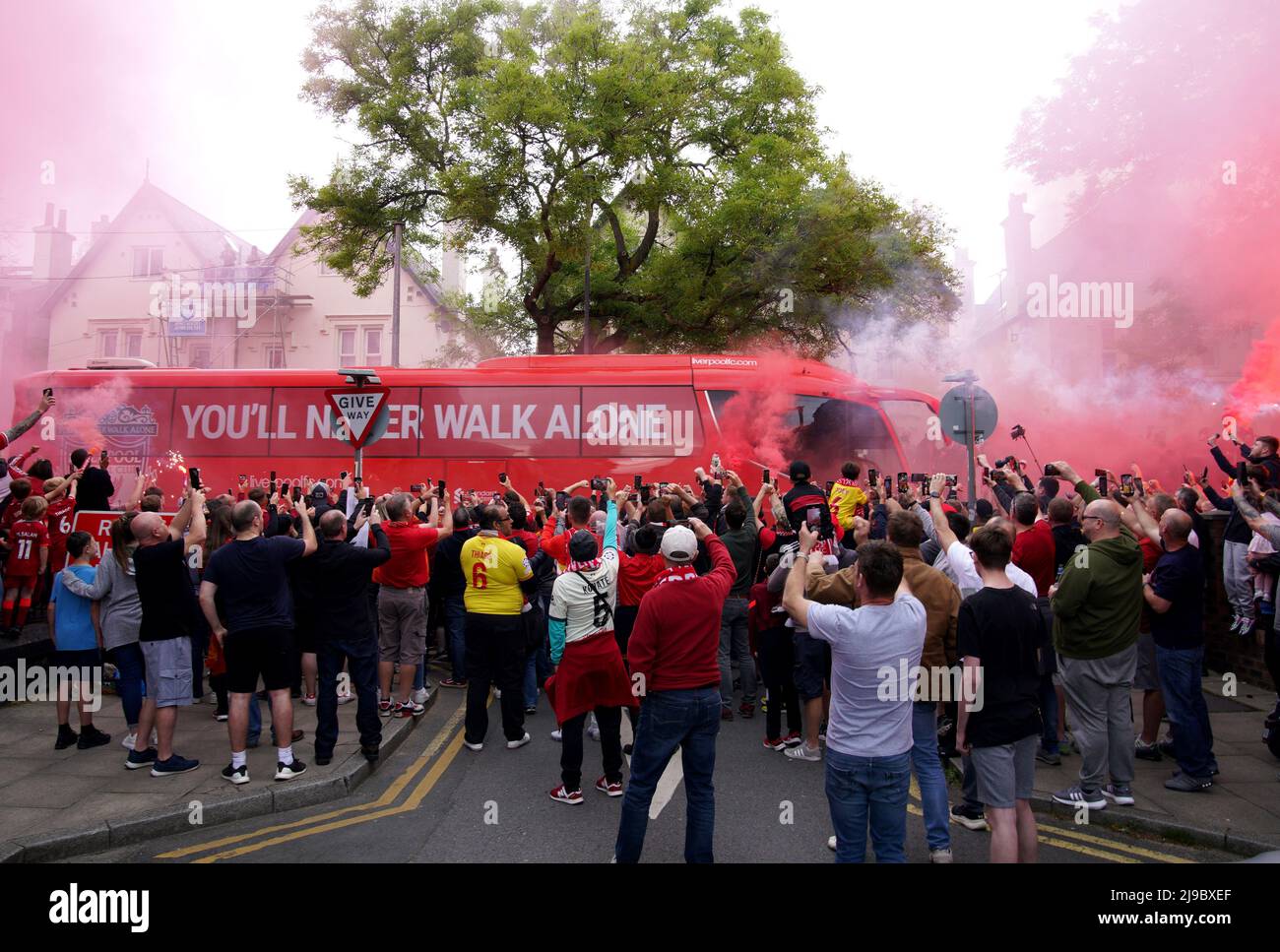 Liverpool fans light flares as they gather outside at the ground to ...
