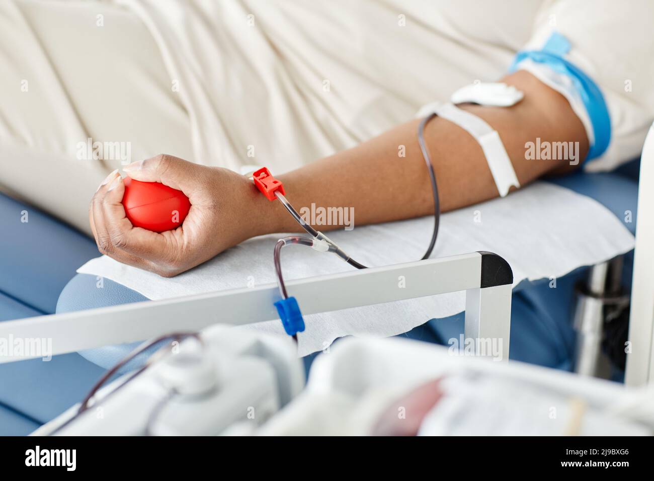 Close up of unrecognizable black woman giving blood while laying in ...