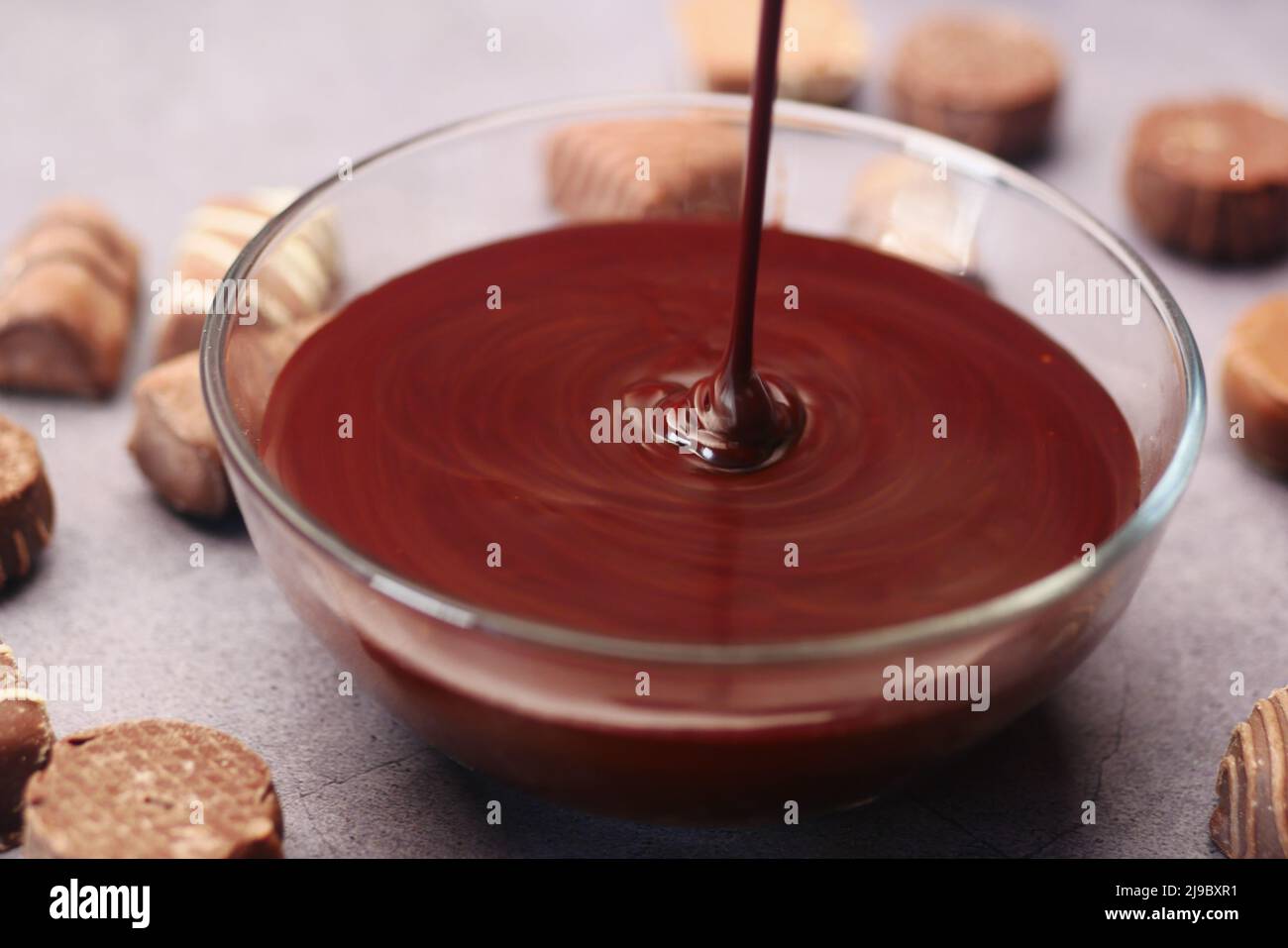 dark chocolate cream pouring in a bowl on table Stock Photo - Alamy