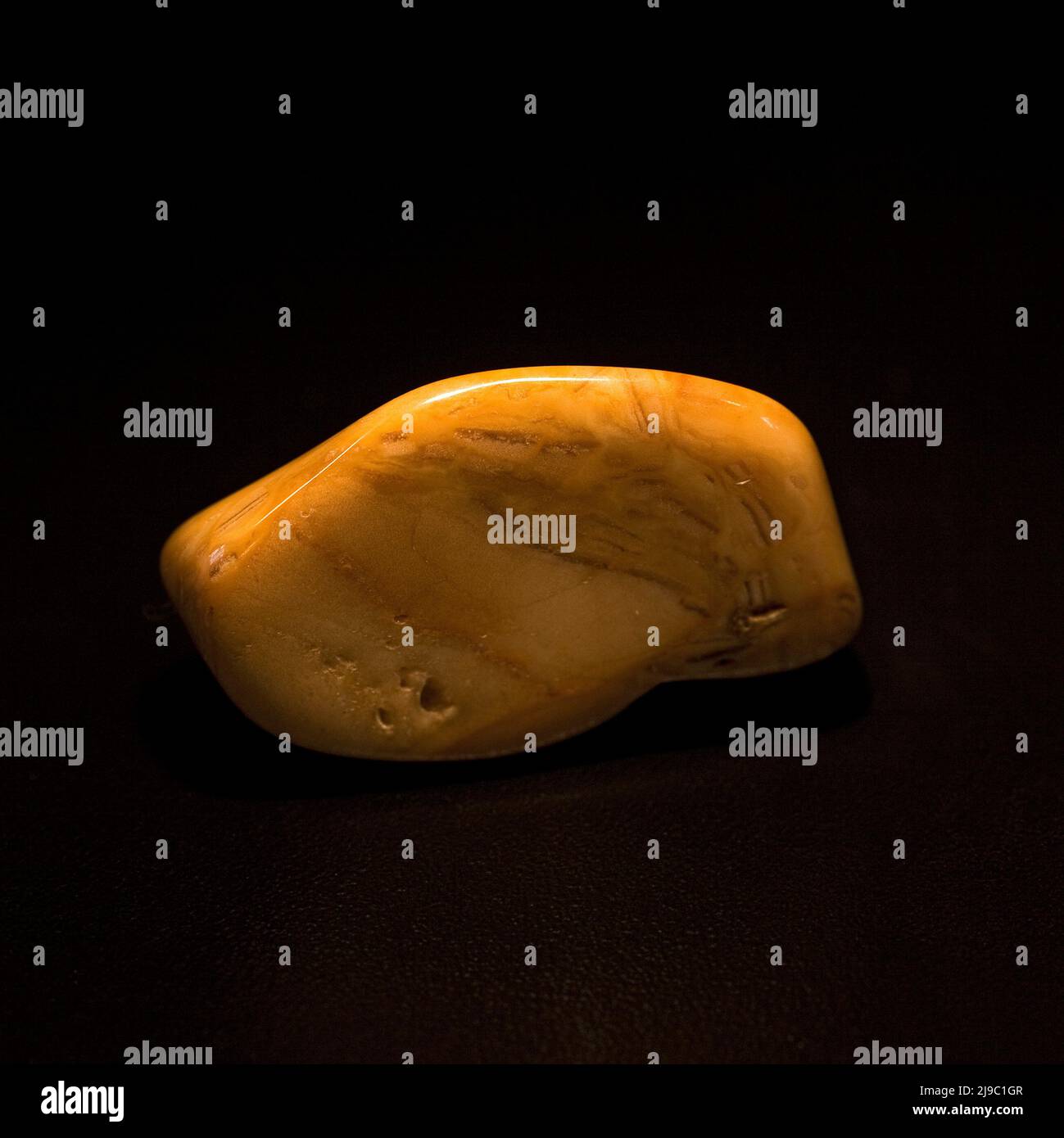 Macro close up colour photograph of a polished 'Yellow Jasper' a semi ...