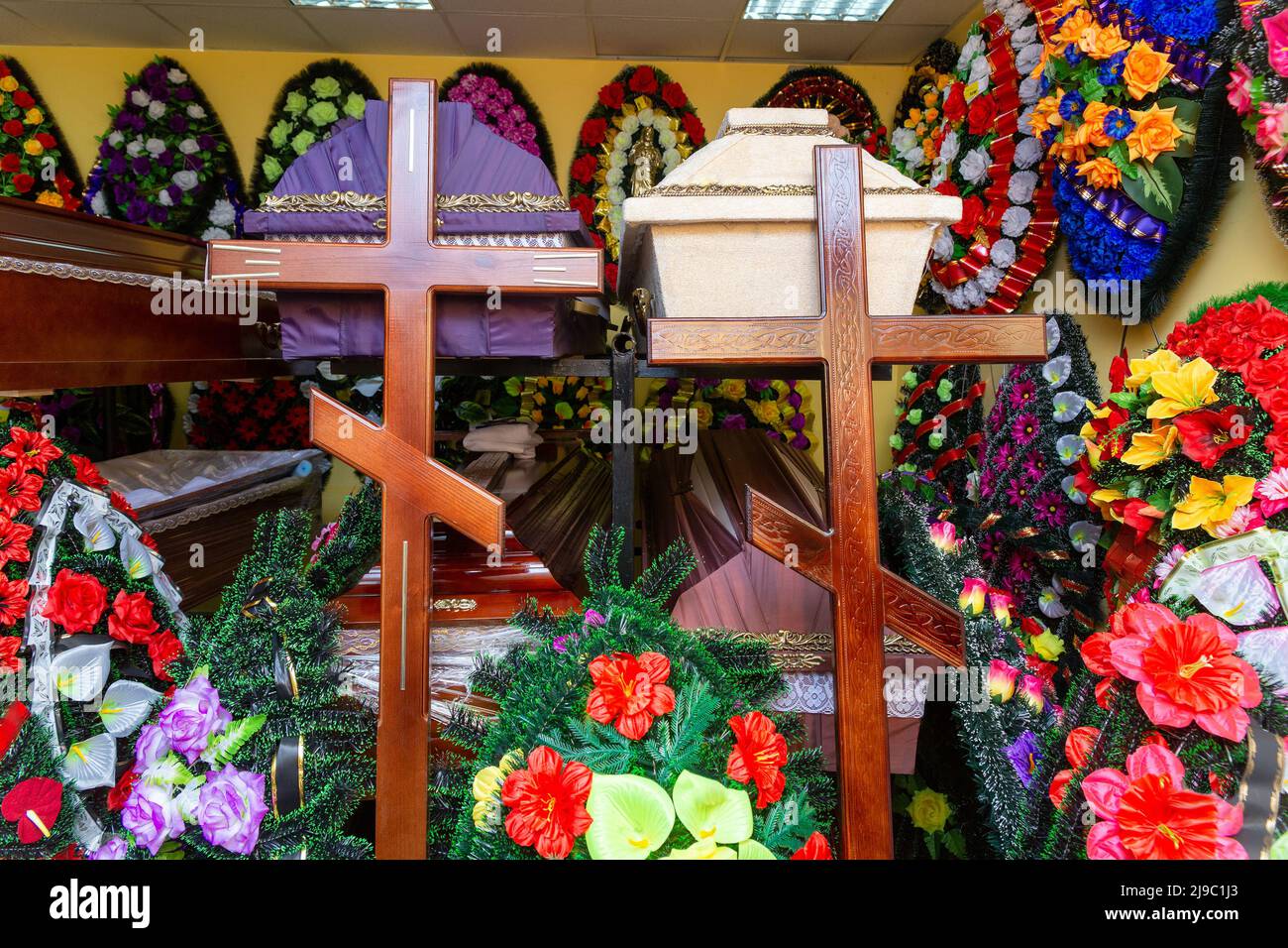 Interior of room with funeral accessories. Shop selling coffins ...