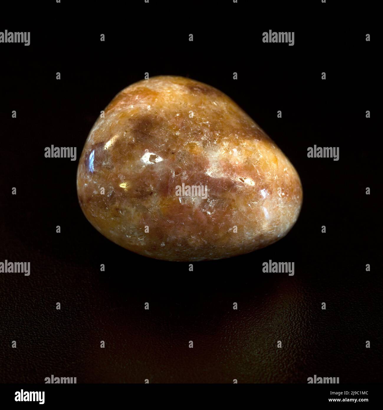 Macro close up colour photograph of a polished 'Orange Magnesite' a ...