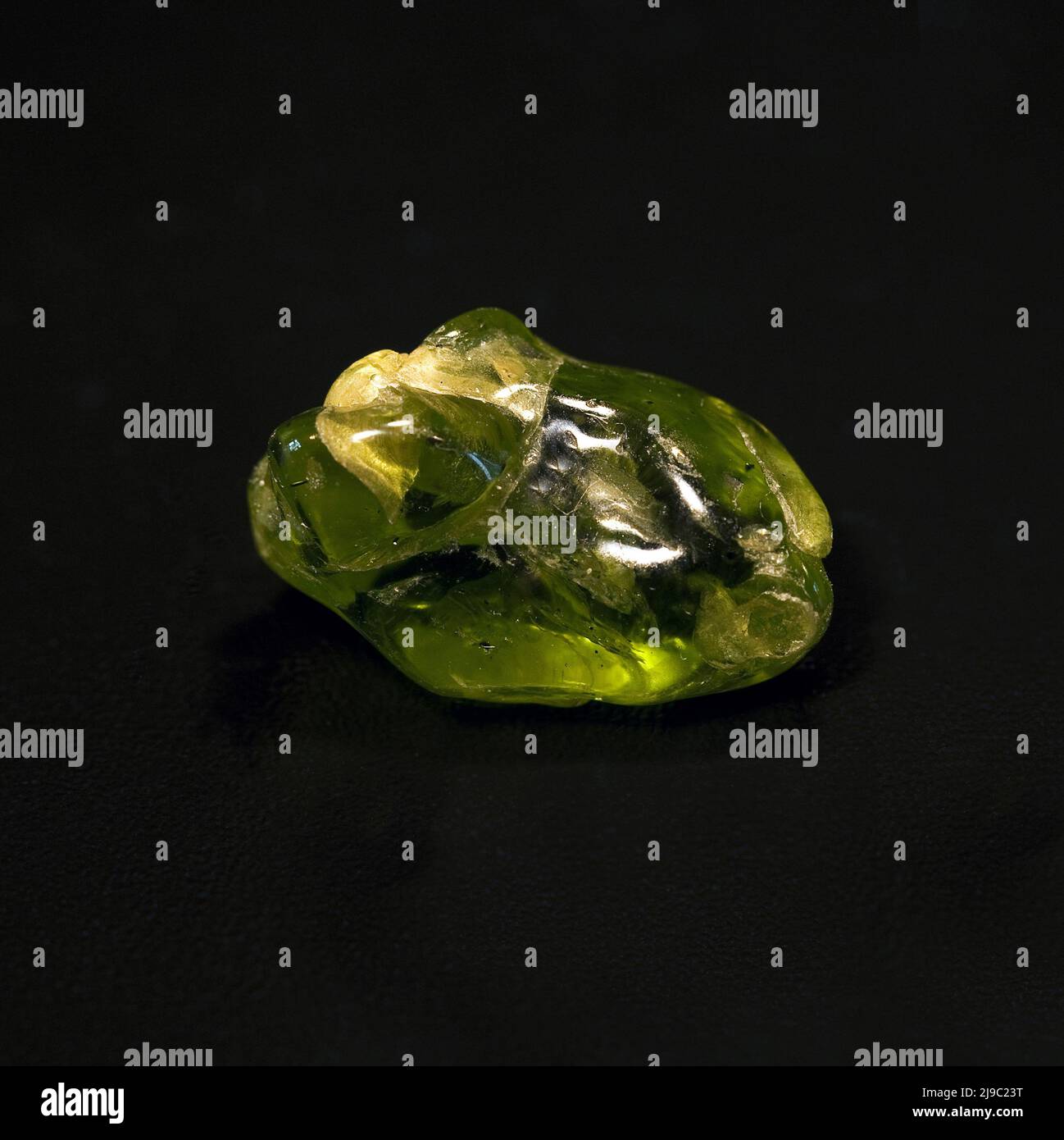 Macro close up colour photograph of a polished 'Peridot' a olive green ...