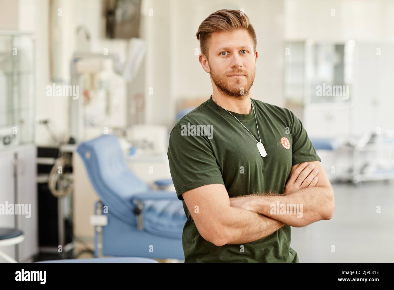 Waist up portrait of proud blood donor standing in med donation center ...