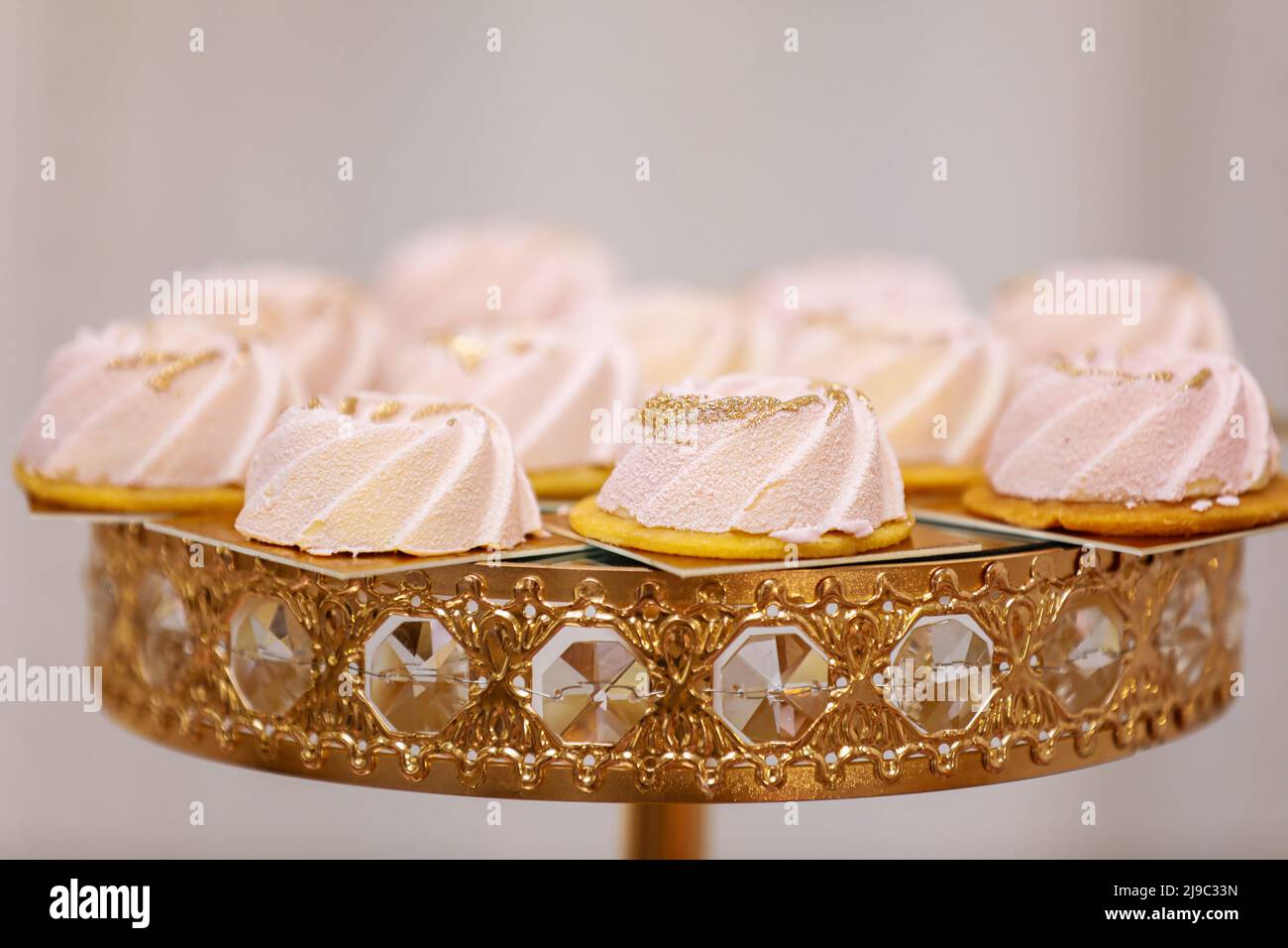 pink mousse dessert on a golden tray. candy bar. festive wedding ...
