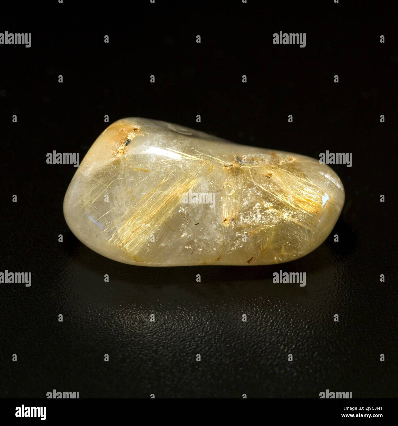 Macro close up colour photograph of 'Rutilated Quartz' a semi precious ...