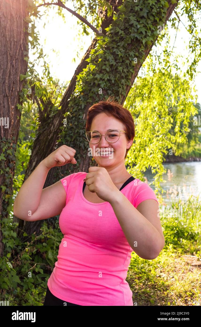 Beautiful young woman trying to get fit for summer; boxing work out in ...
