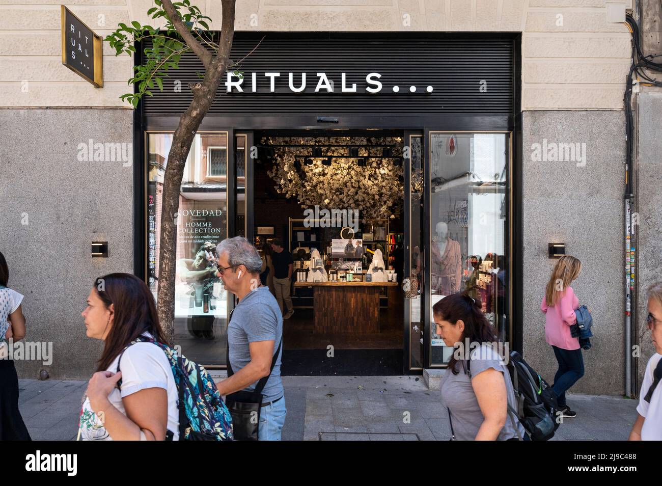 Pedestrians walk past the Dutch cosmetics brand Rituals store in Spain ...