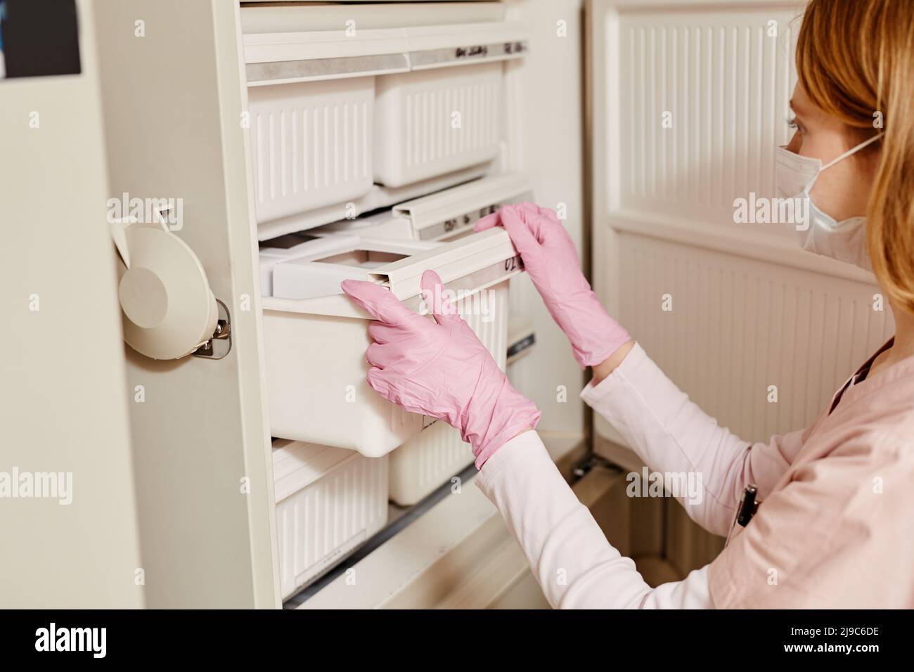 Close up of female nurse opening storage fridge at blood donation ...