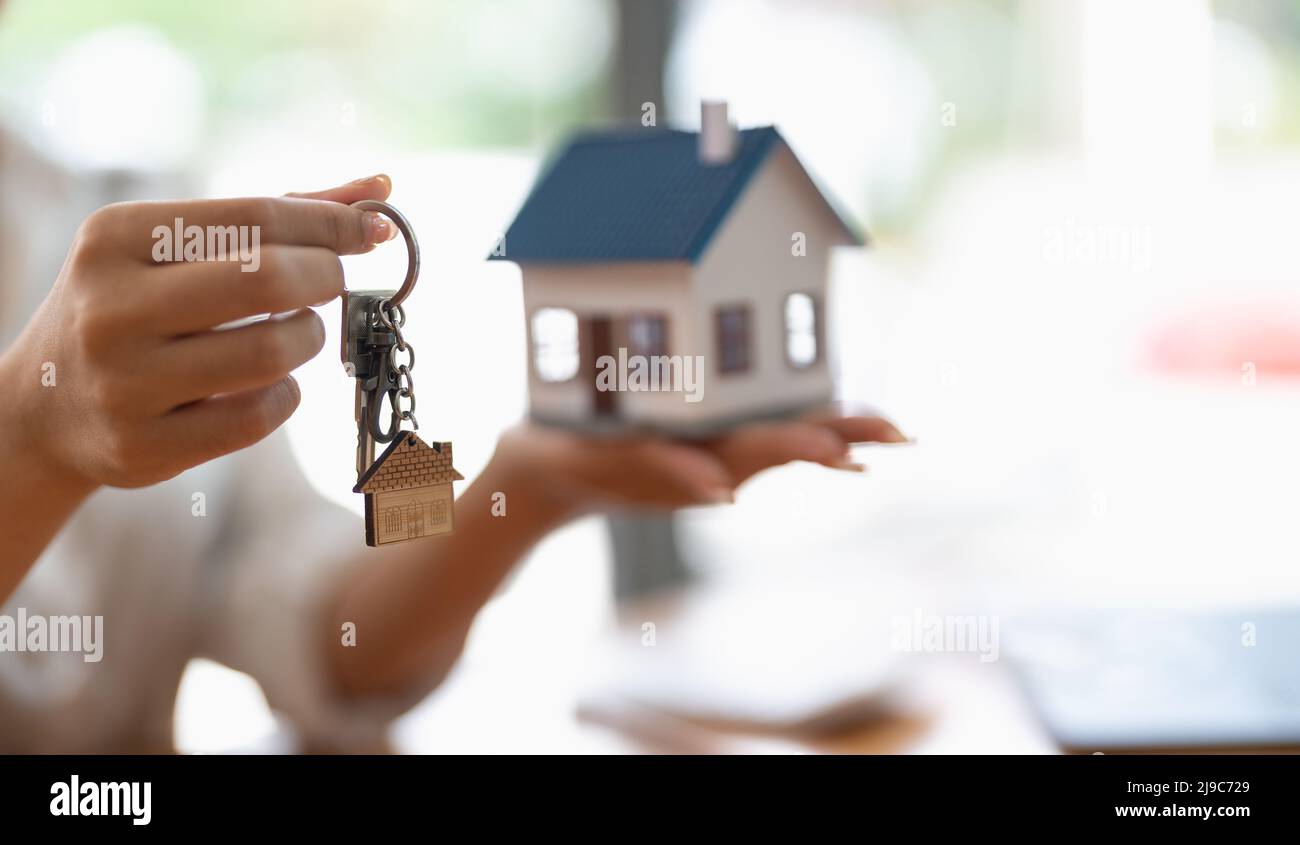 Real estate agent handing over keys to home Stock Photo - Alamy