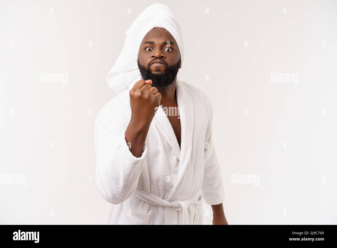 Portrait of excited young African American male screaming in shock and amazement holding hands ...