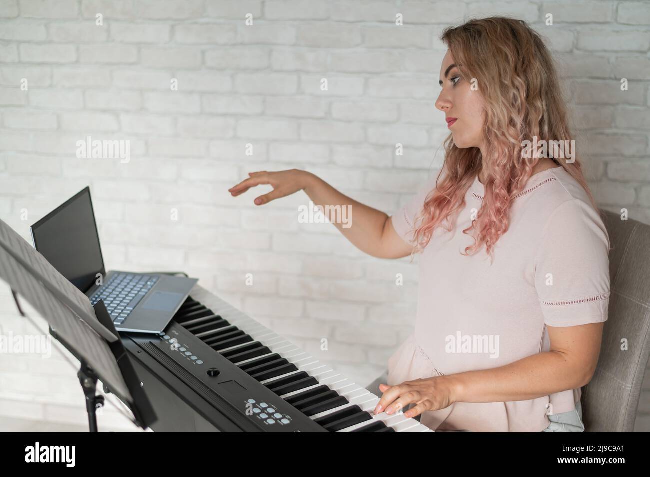 Remote music lessons. A singing teacher records the lesson on a laptop ...