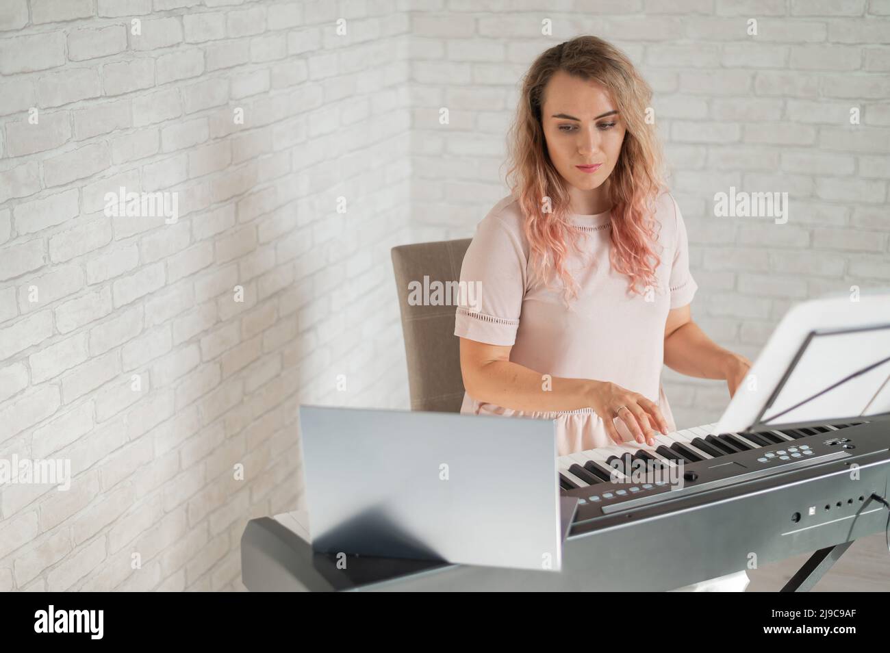 Remote music lessons. A singing teacher records the lesson on a laptop ...