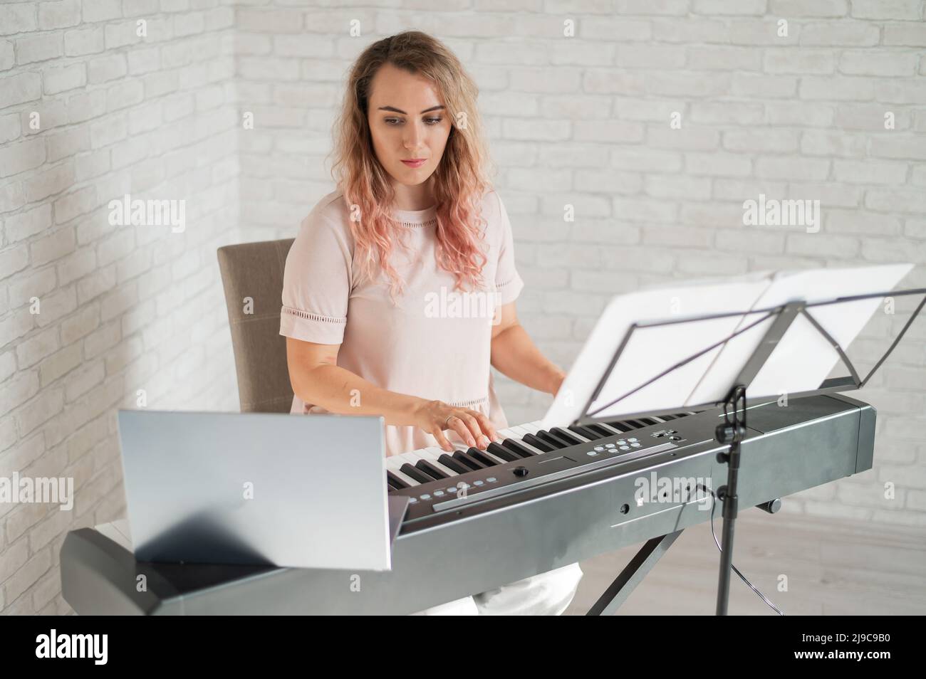 Remote music lessons. A singing teacher records the lesson on a laptop ...