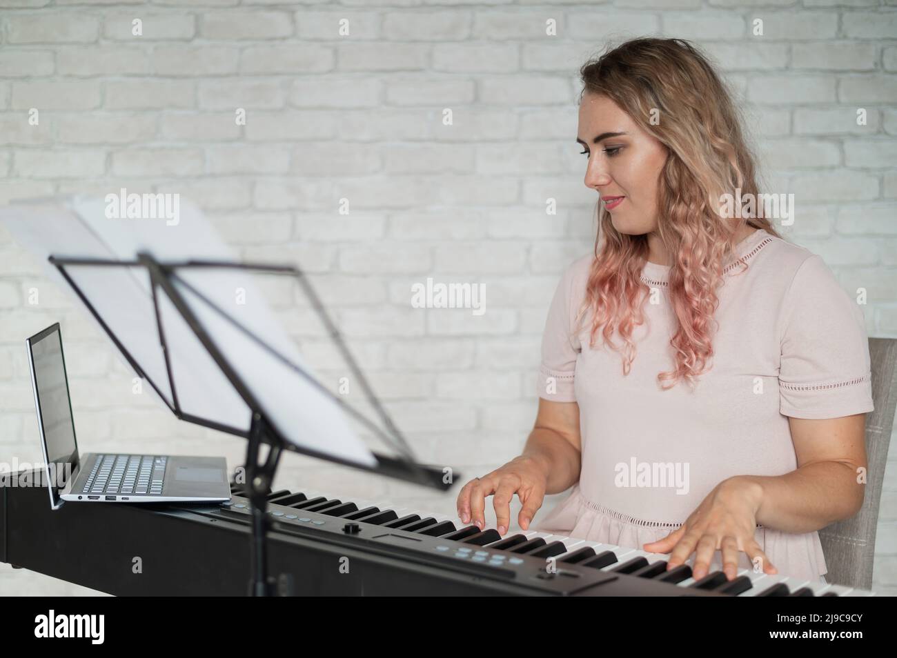 Remote music lessons. A singing teacher records the lesson on a laptop ...