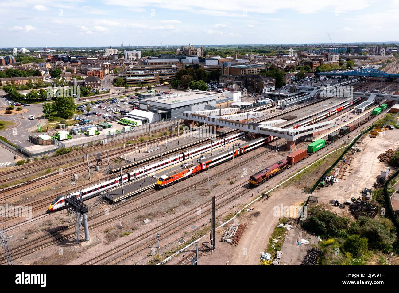 An aerial landscape view of passenger and freight trains waiting on the ...