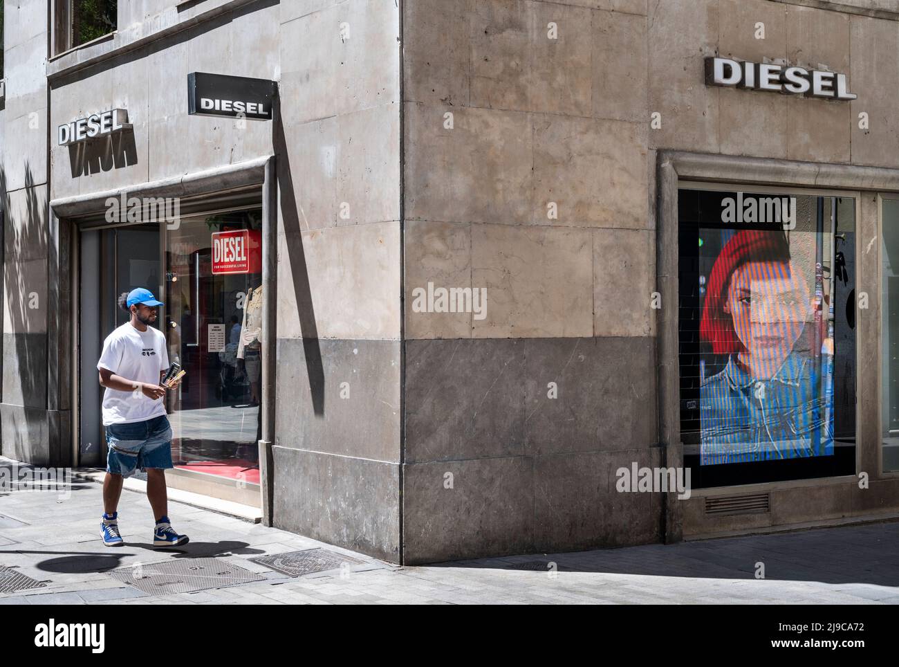 A pedestrian walks past the Italian retail clothing brand Diesel store ...