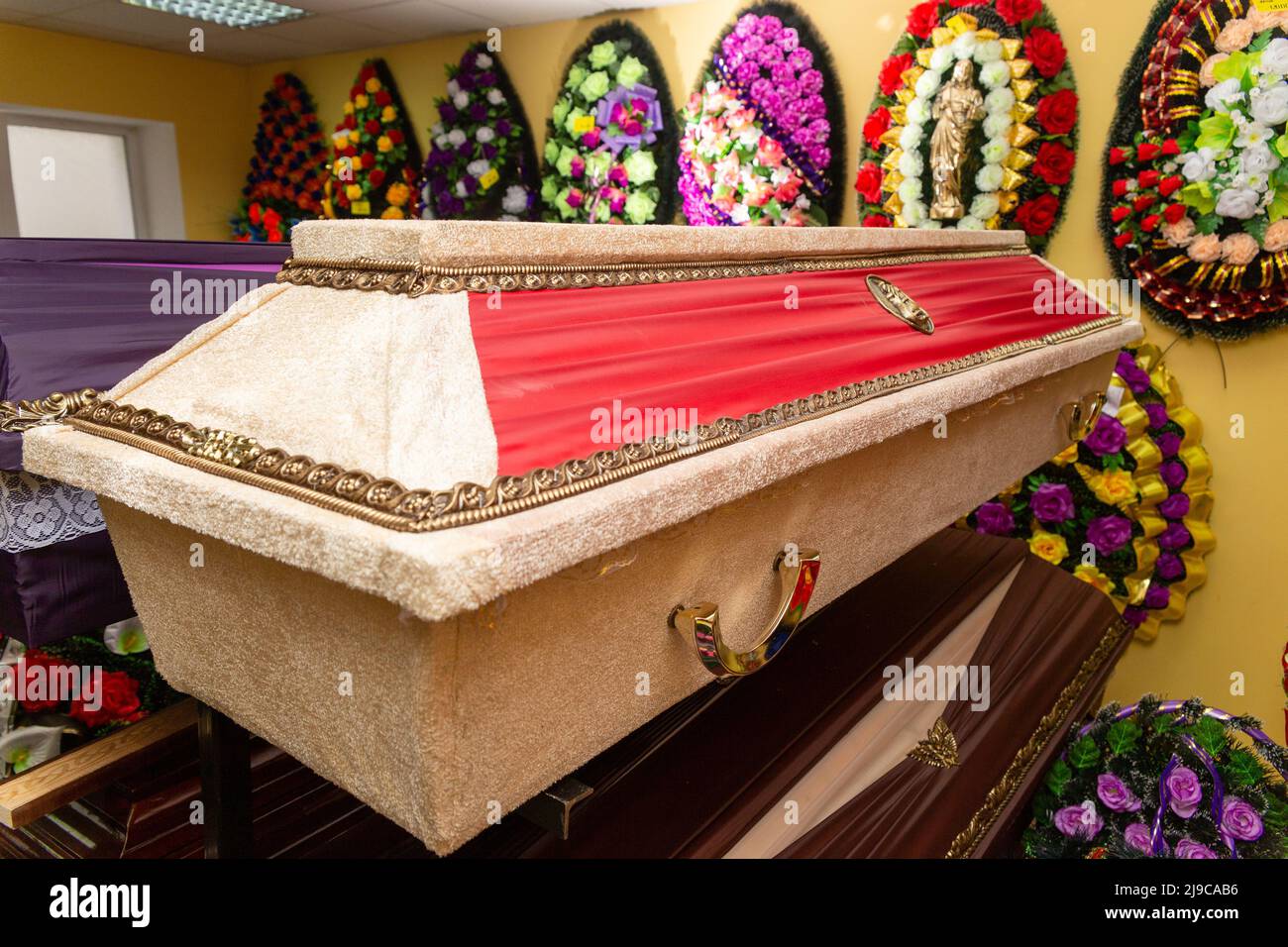Interior of room with funeral accessories. Shop selling coffins ...