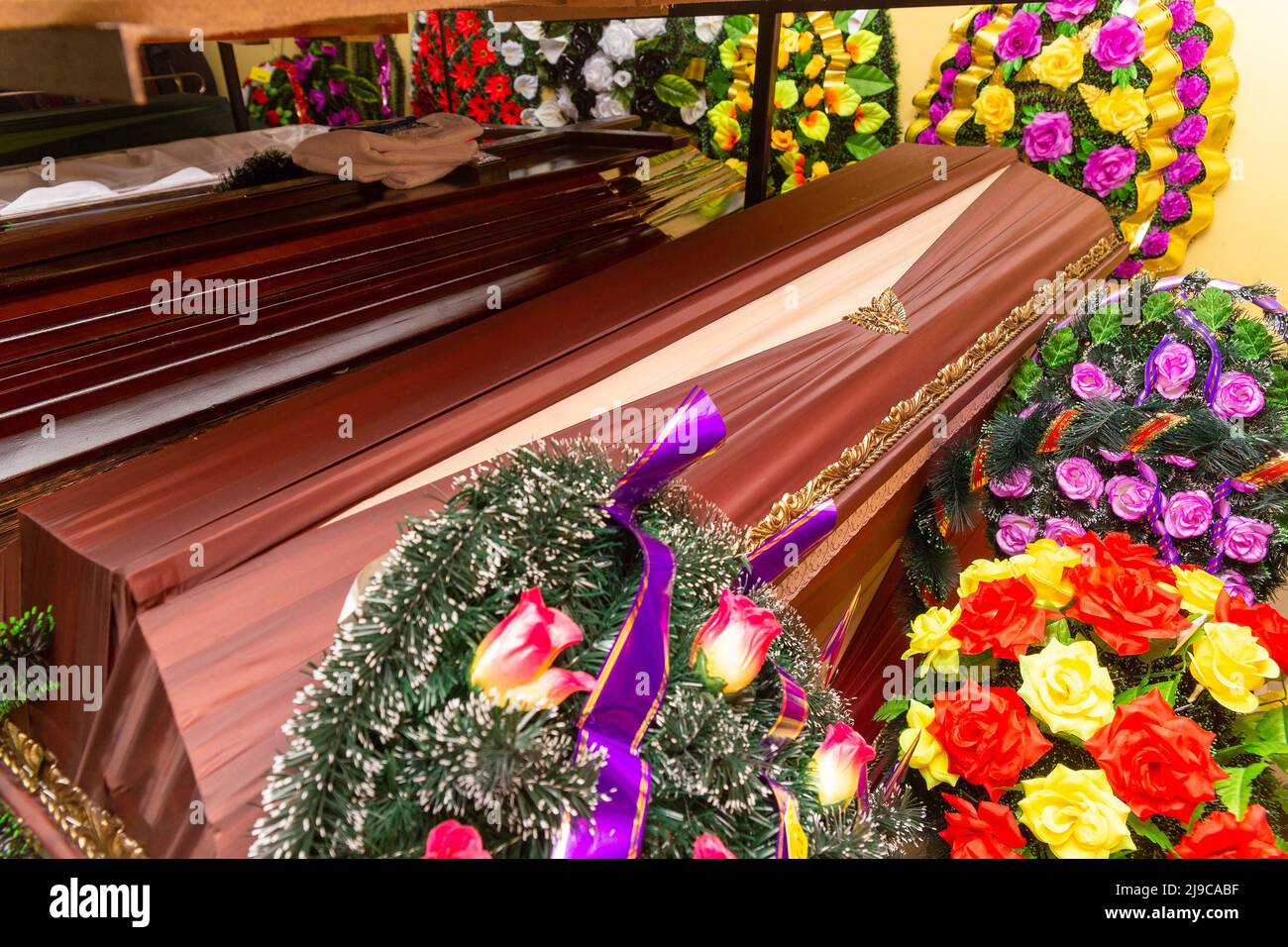 Interior of room with funeral accessories. Shop selling coffins ...