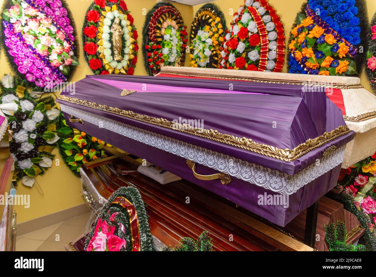 Interior of room with funeral accessories. Shop selling coffins ...