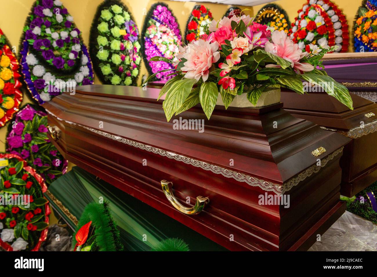 Interior of room with funeral accessories. Shop selling coffins ...