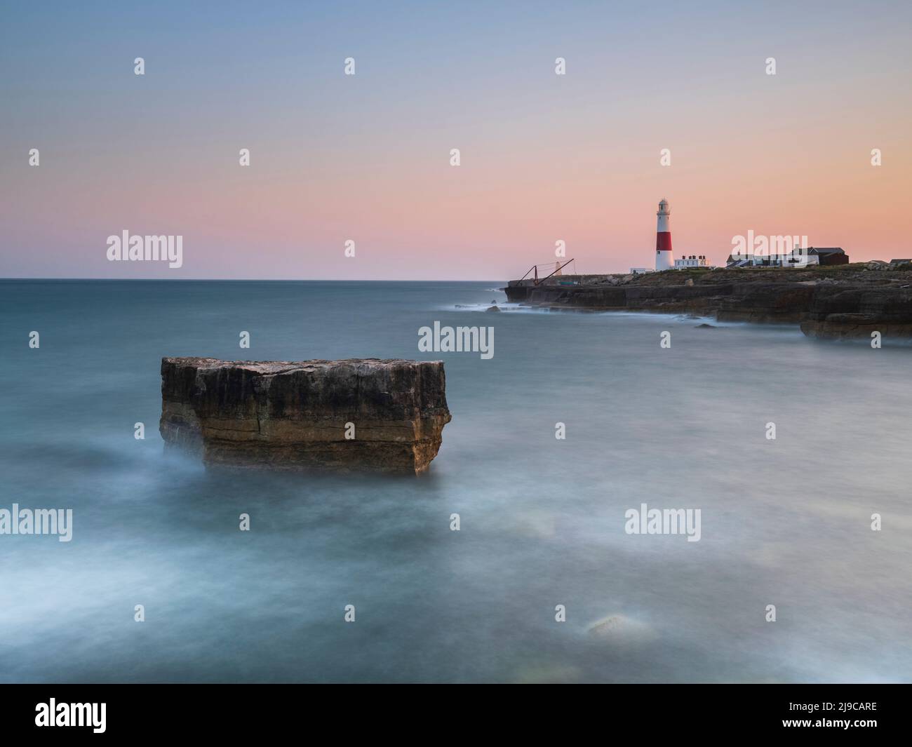 Waves washing around a rock stack at Portland Bill in Dorset with the ...