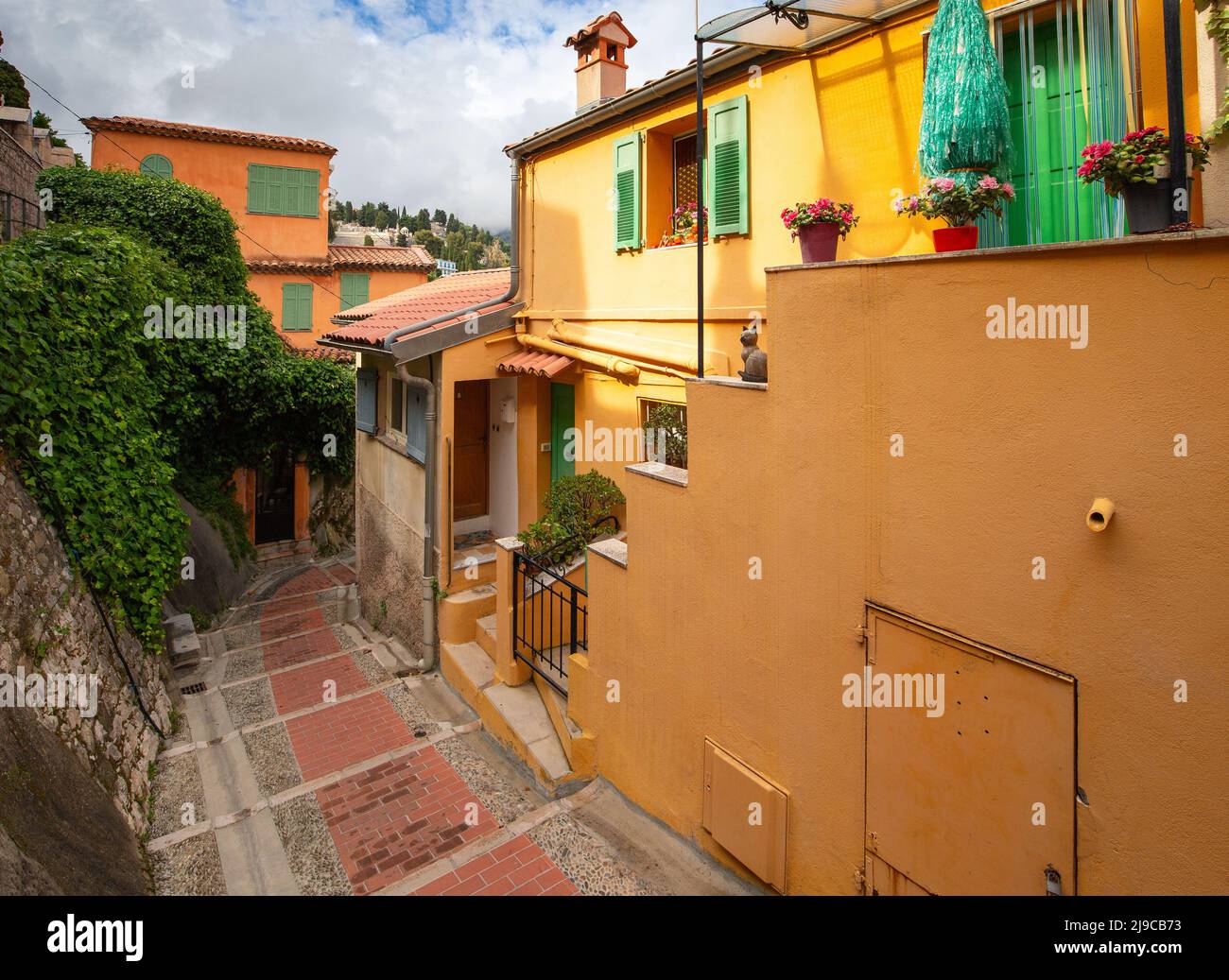 Old medieval narrow street in the historical part of the city. Menton ...