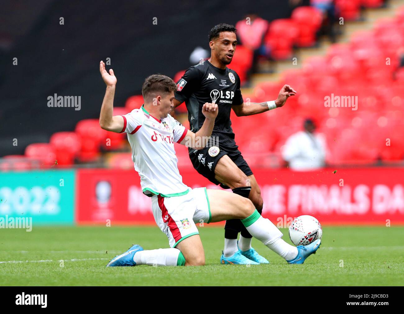 Wrexham's Jordan Davies (left) tackles Bromley's Corey Whitely during ...