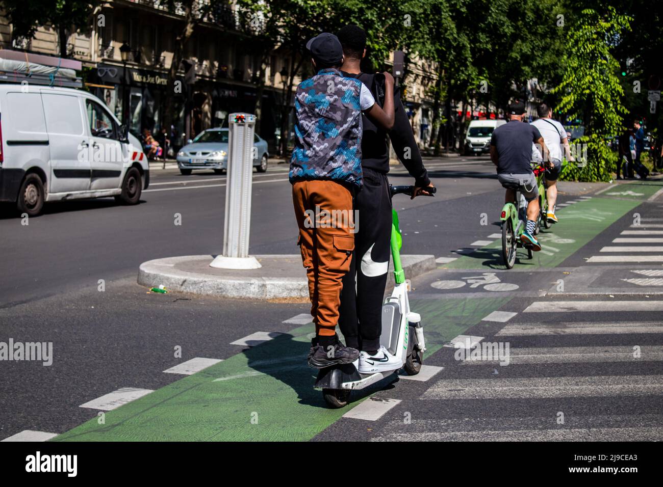 Paris, France - May 21, 2022 People rolling with an electric scooter in ...