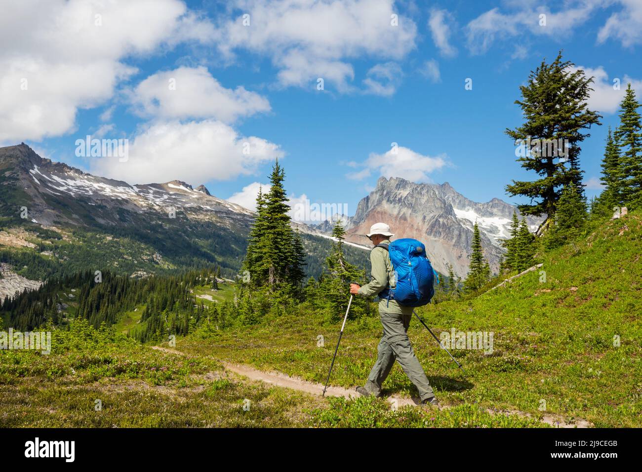 Backpacker in hike in the high mountains Stock Photo - Alamy