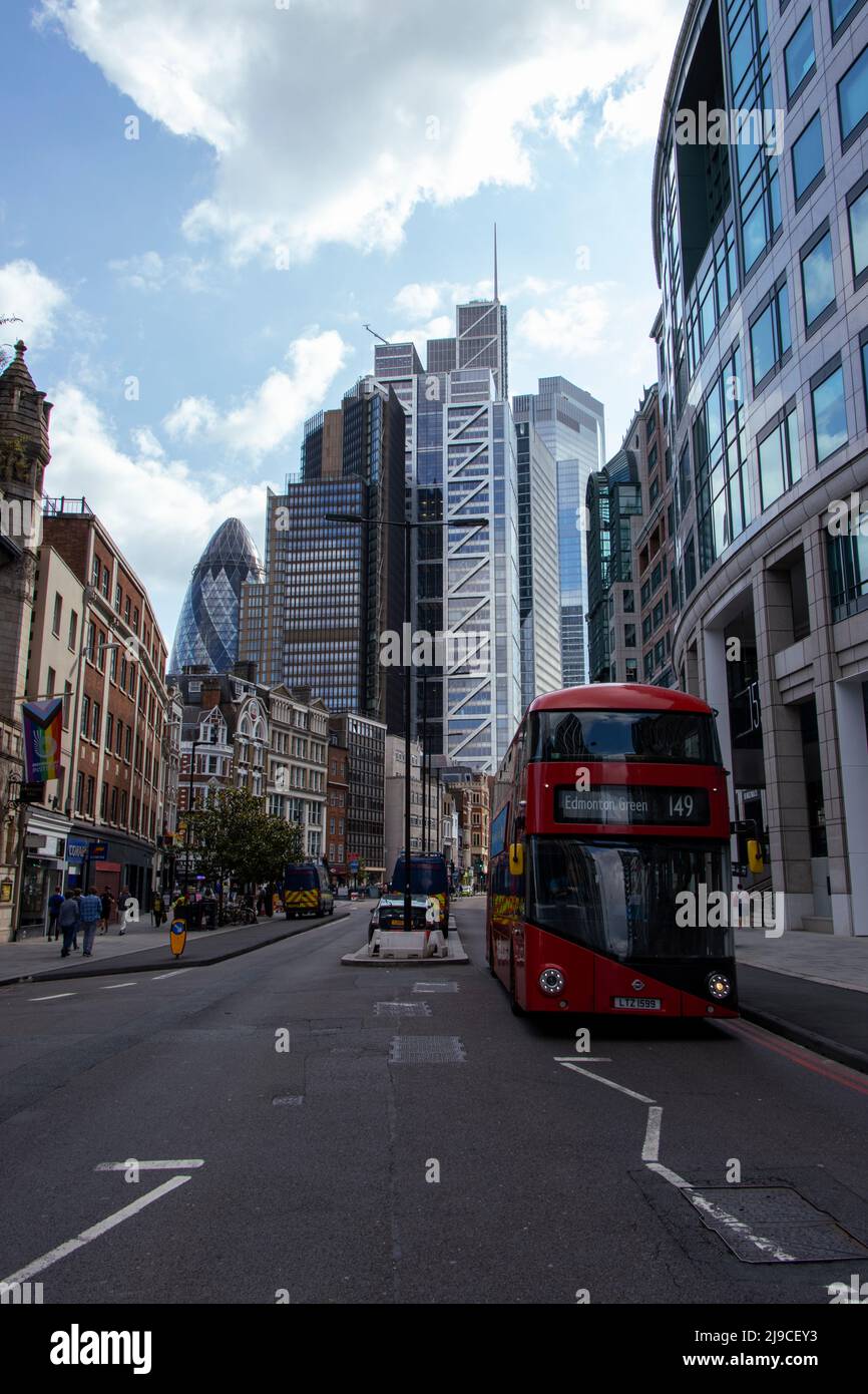 Portrait shot of London city skyscrapers and iconic London red bus ...