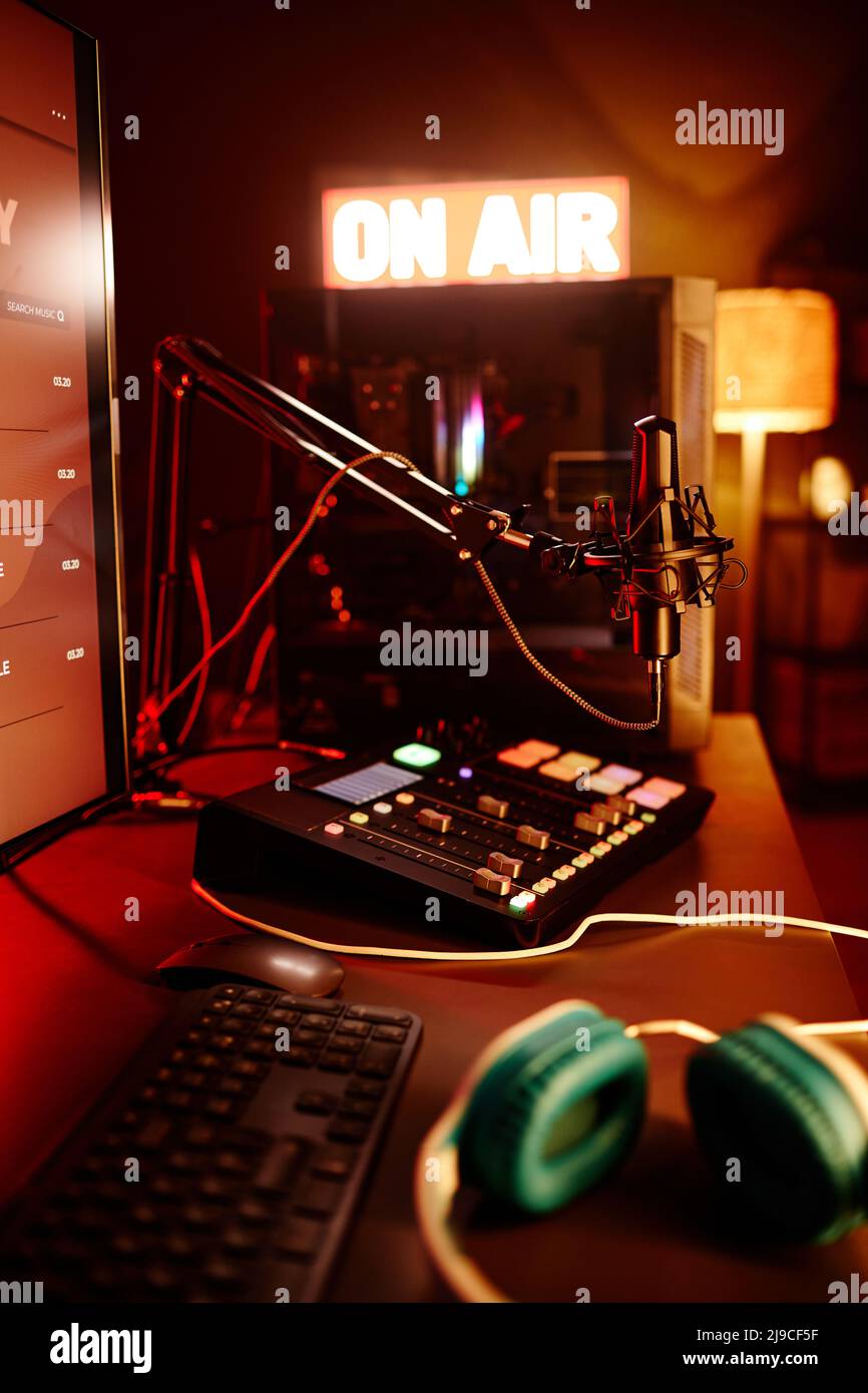 Vertical no people shot of computer, headphones, microphone and mixing ...