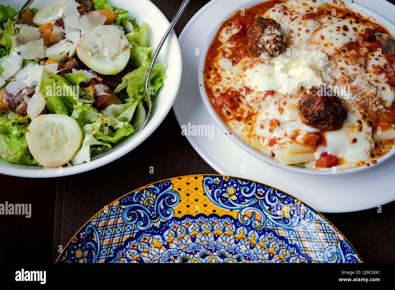 Lasagna and vegetable salad on the table Stock Photo - Alamy