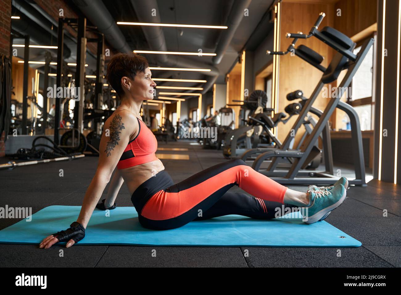 Female athlete resting on floor after gym workout Stock Photo - Alamy