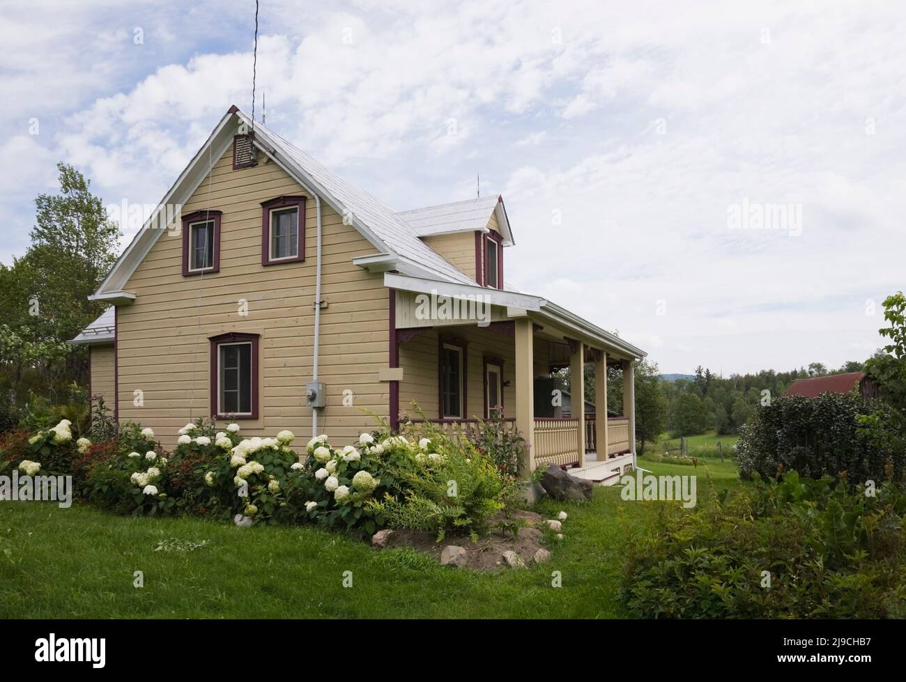 Old circa 1850 Canadiana cottage style home with beige wood plank ...