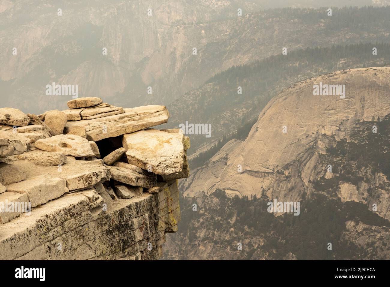Empty Ledge Looks Over Yosemite Valley From Half Dome On Smoky Day in ...