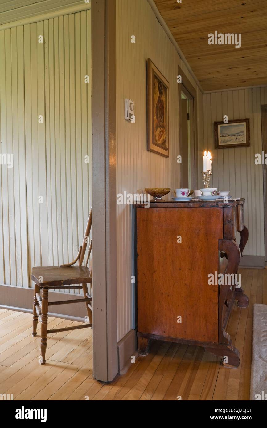 Antique chair in dining room and dresser and furnishings in living room ...