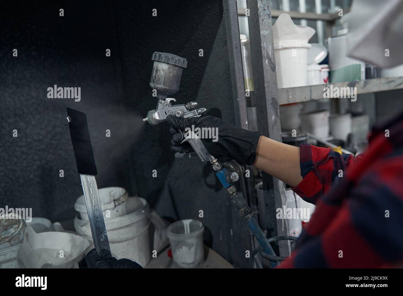 Focused photo on master that spraying color on sample Stock Photo - Alamy